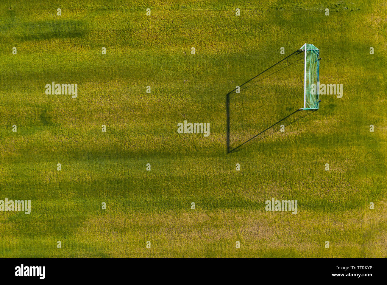 Drone view of football gates on field with green lawn in sunny day ...