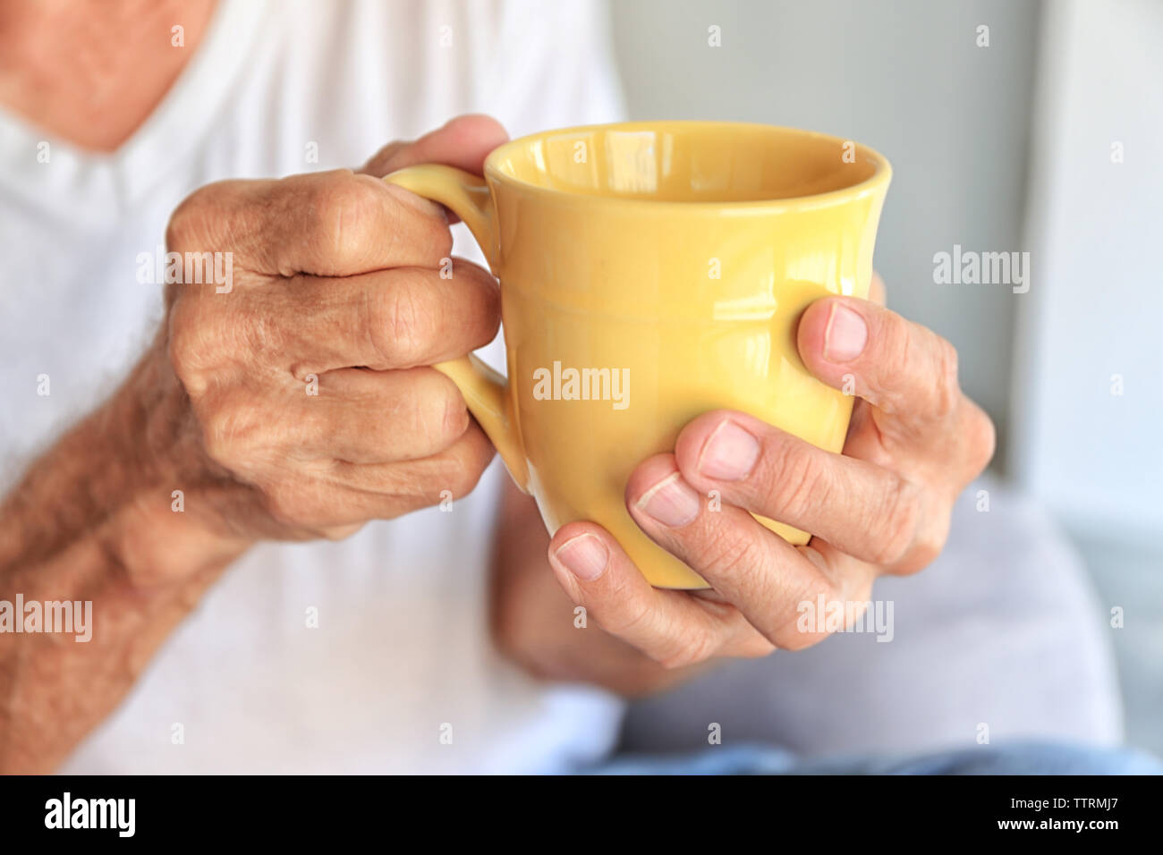 Tired senior man holding coffee hi-res stock photography and images - Alamy