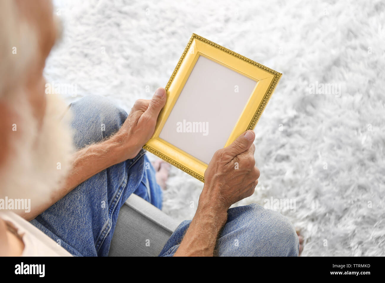 Old man holding photo frame Stock Photo - Alamy