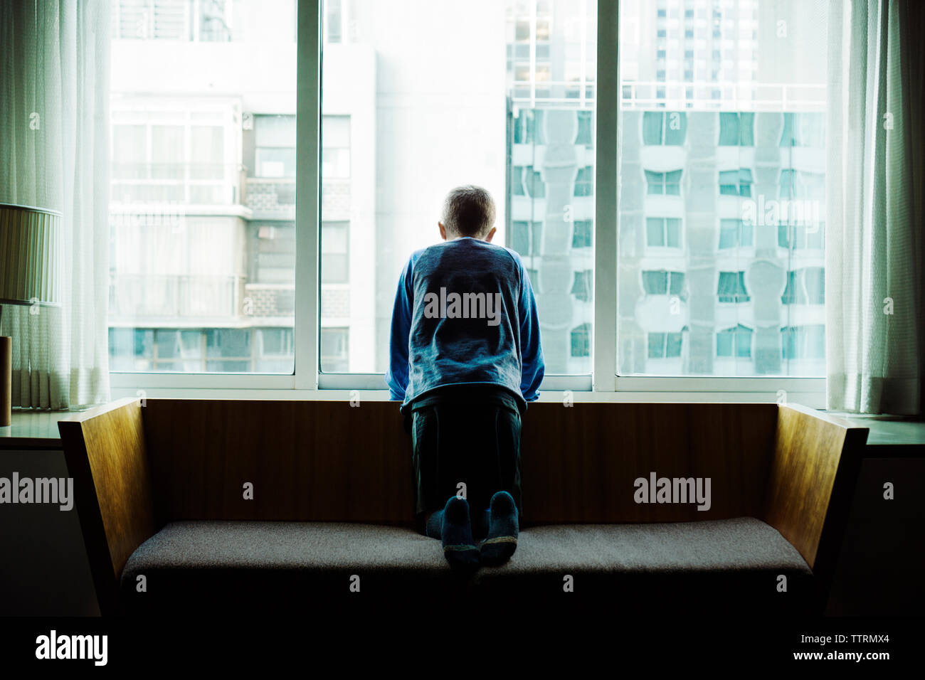 Kneeling on sofa hi-res stock photography and images - Alamy