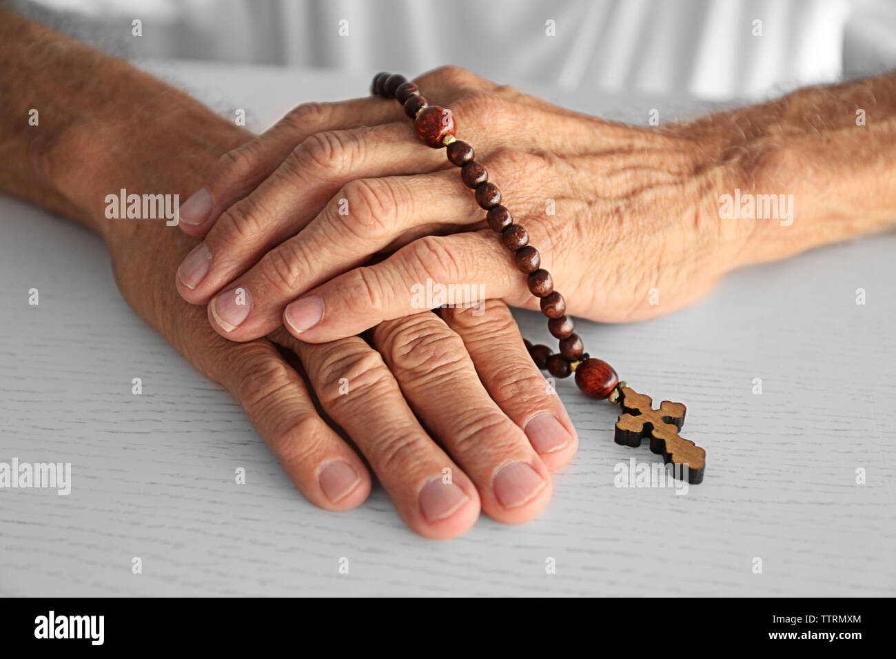 Praying hands old man rosary hi-res stock photography and images - Alamy