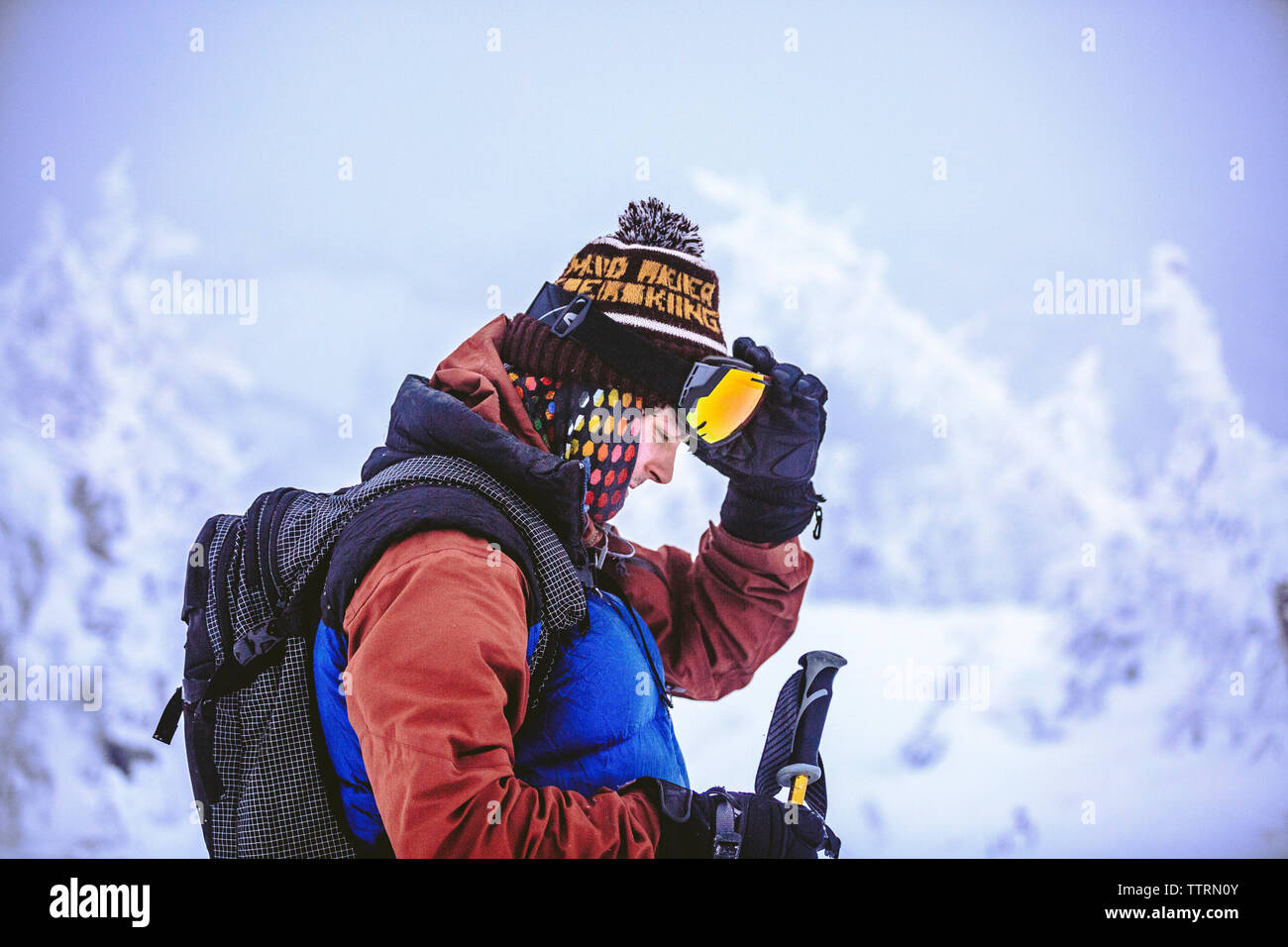 Side view of man preparing for skiing Stock Photo - Alamy