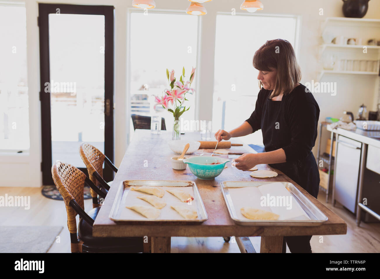 Side view of woman making food at home Stock Photo - Alamy