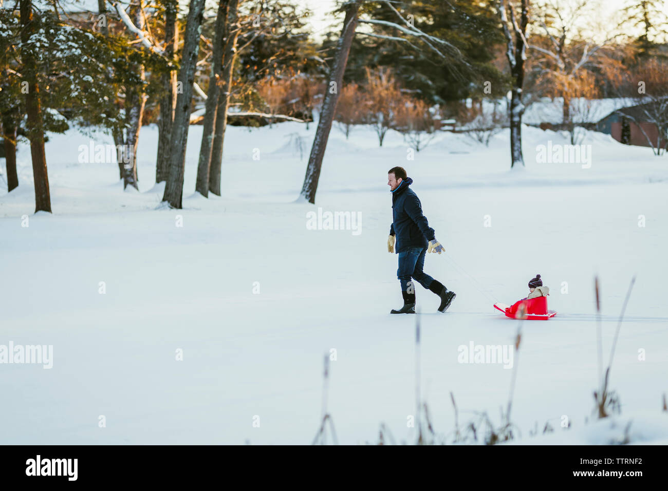 Parent pulling girl sled hi-res stock photography and images - Alamy