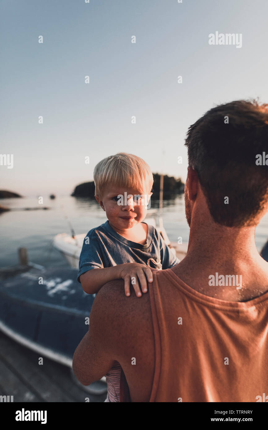 Boy standing at pier hi-res stock photography and images - Alamy