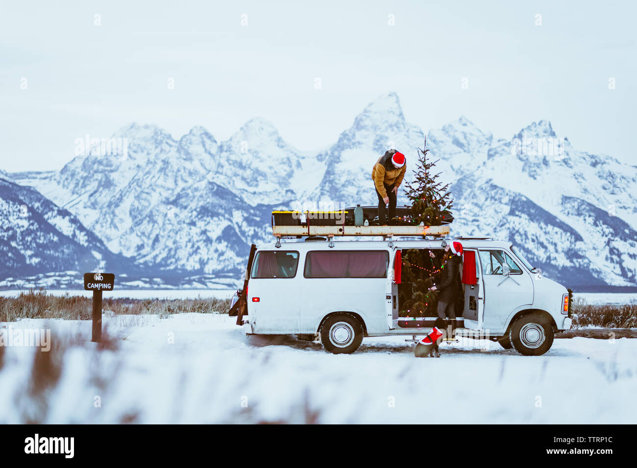 Decorating old school white passenger van with christmas lights Stock ...