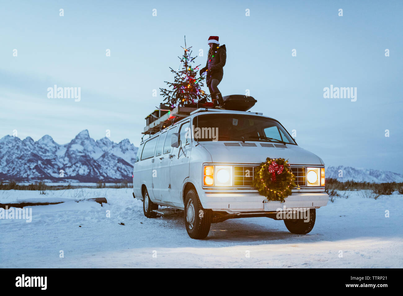 Old Passenger van decorated for christmas with woman on top Stock Photo ...