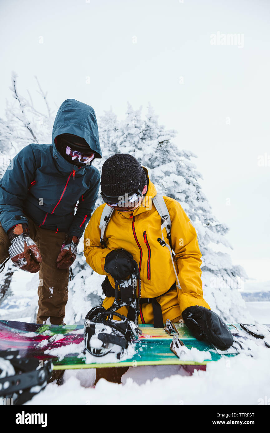 two snowboarders get their boards ready Stock Photo - Alamy