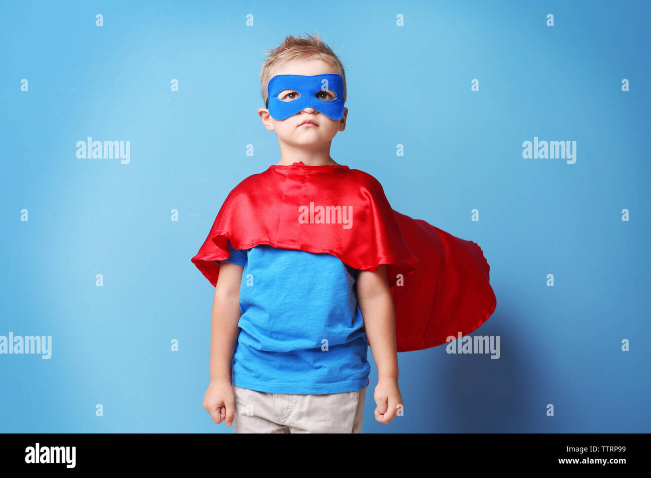Superhero kid on blue background Stock Photo - Alamy
