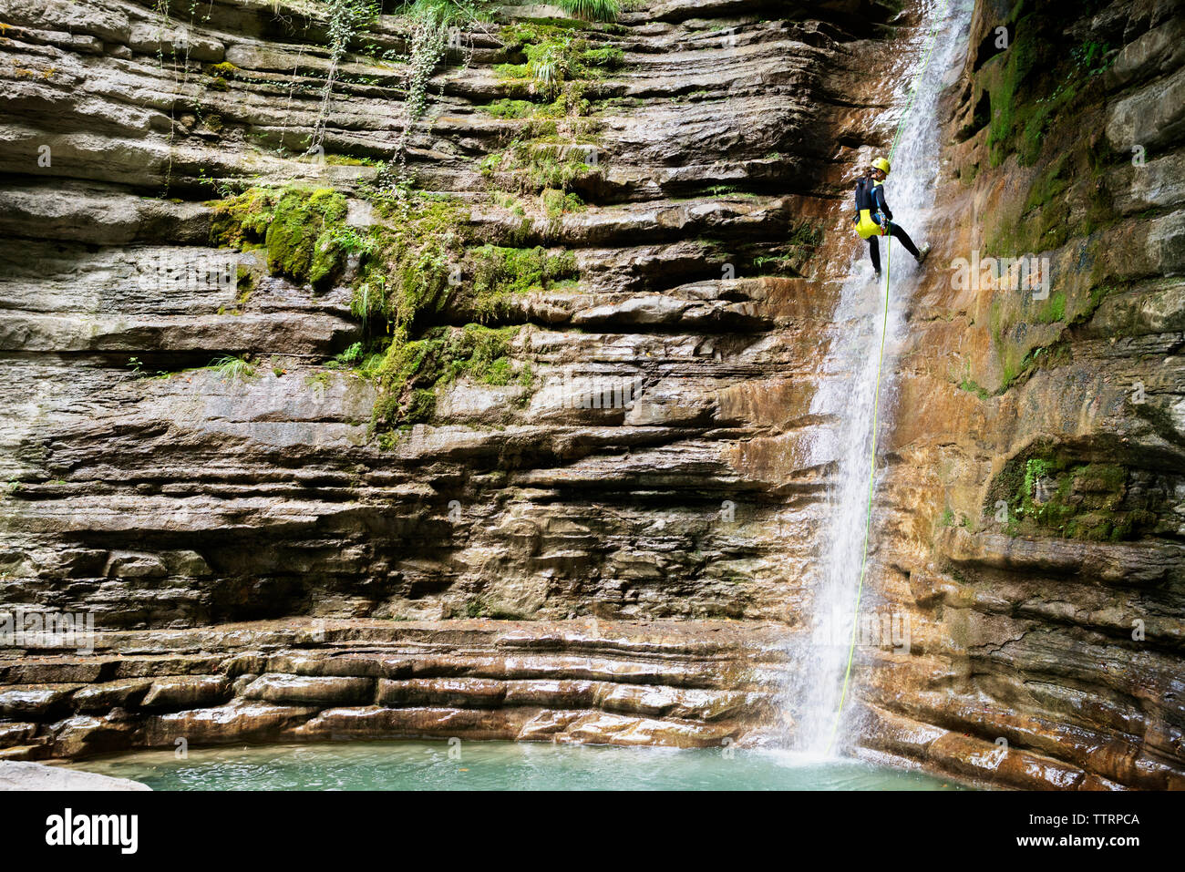 Woman rappelling down waterfall hi-res stock photography and images - Alamy