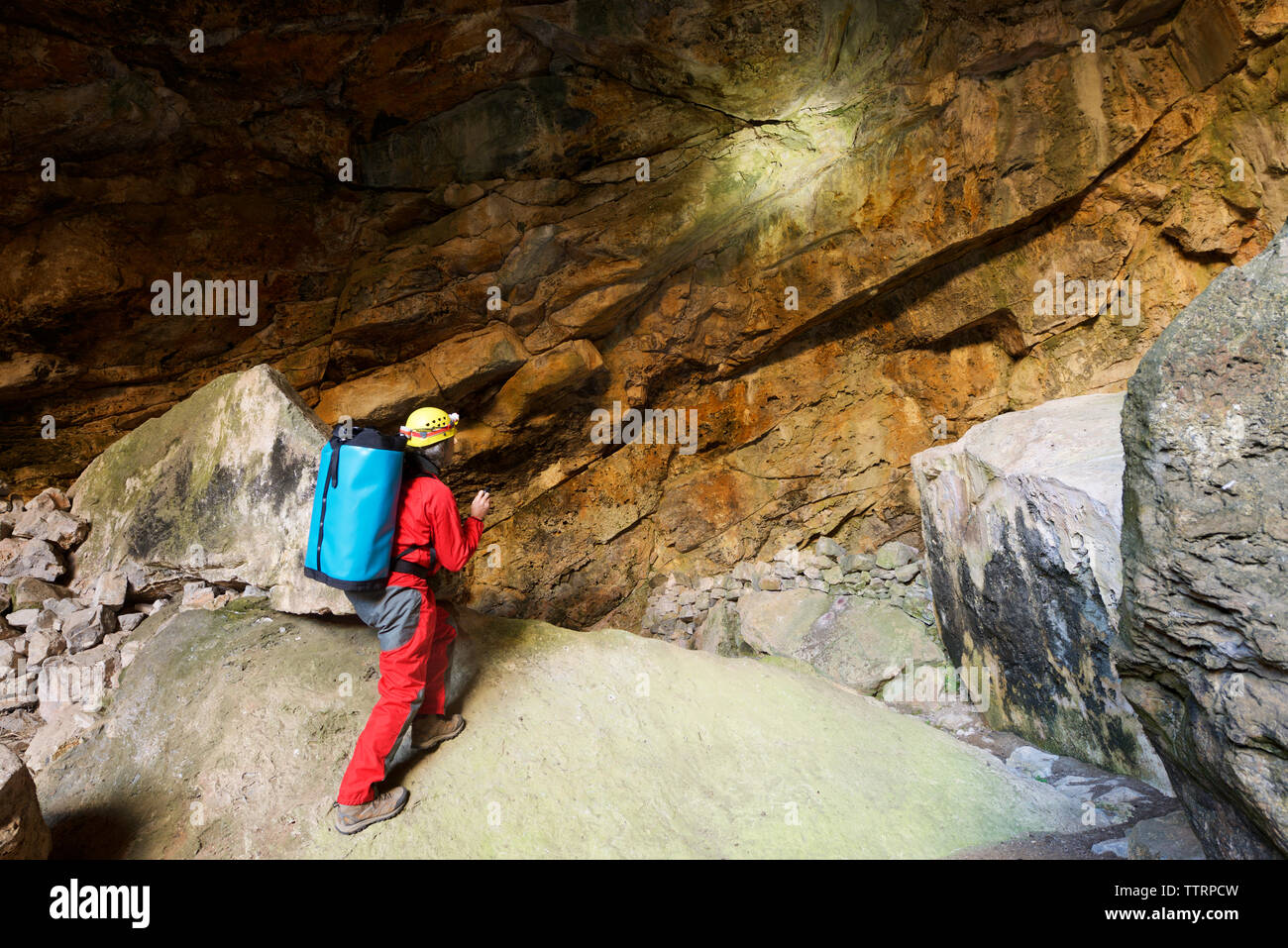 Full length of archaeologist standing in cave Stock Photo - Alamy