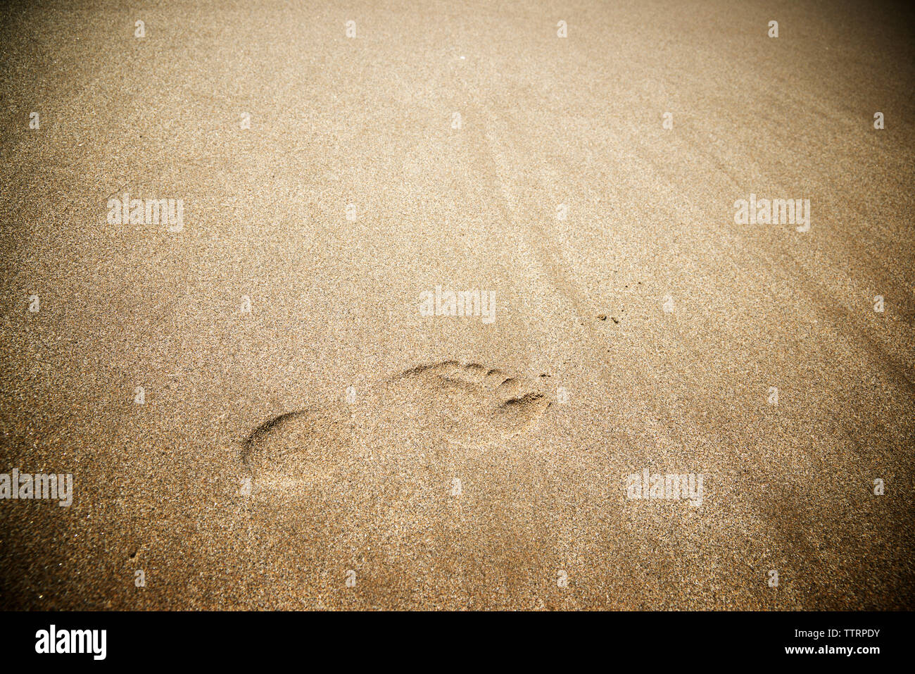 High angle view of foot mark on sand at beach Stock Photo - Alamy