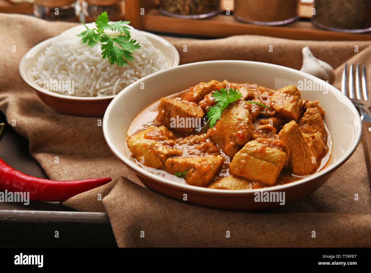 Tasty dinner with chicken curry in plate on tray Stock Photo - Alamy