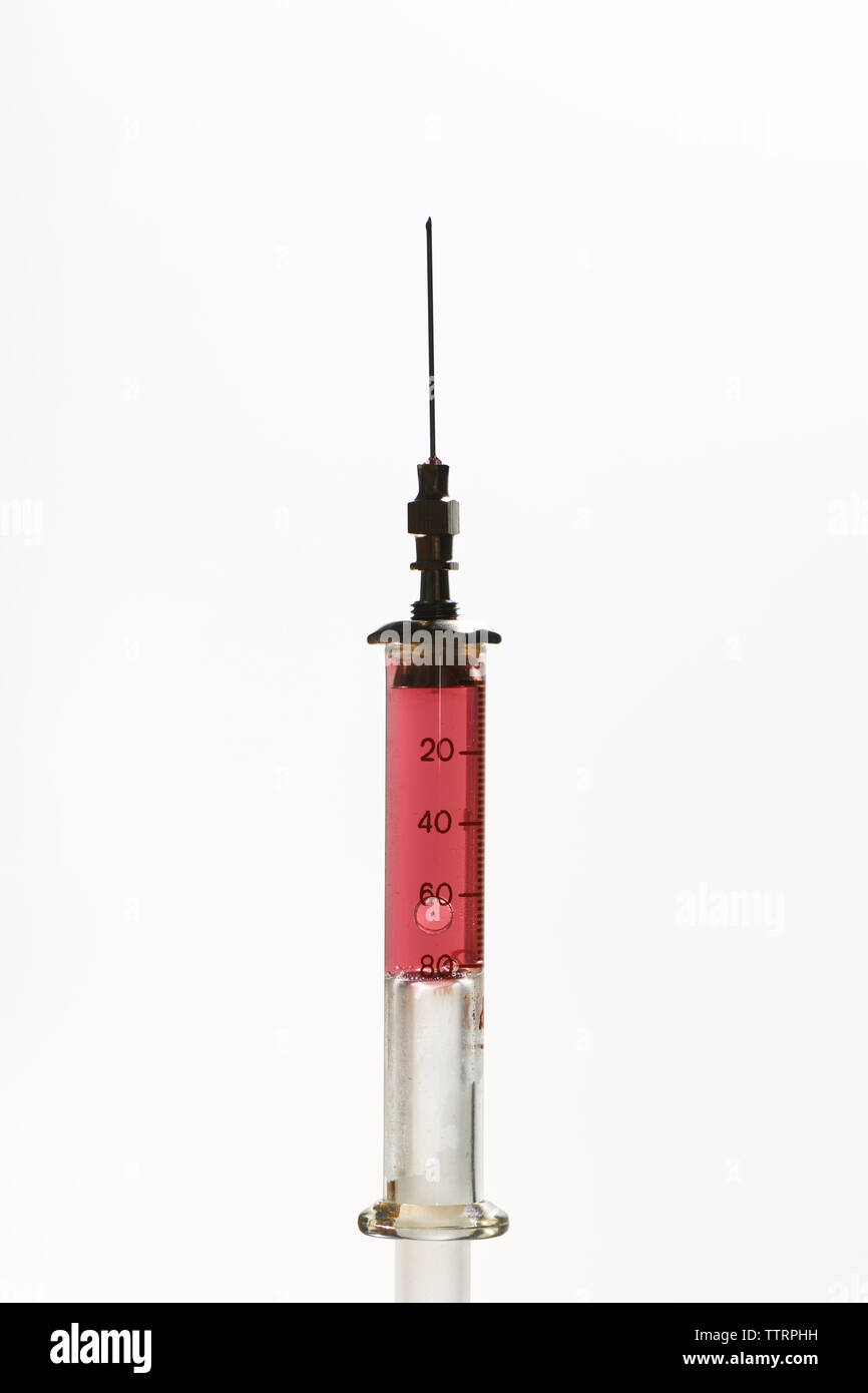 Close-up of syringe on white background Stock Photo - Alamy