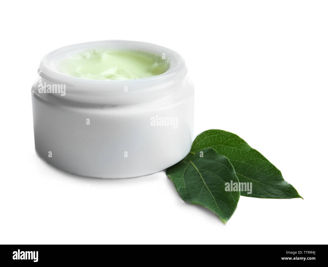Facial cream and green leaves on white background Stock Photo - Alamy
