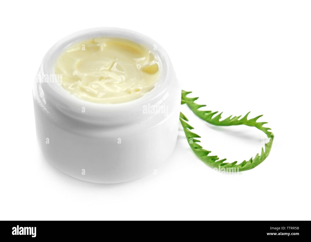 Facial cream and green leaves on white background Stock Photo - Alamy