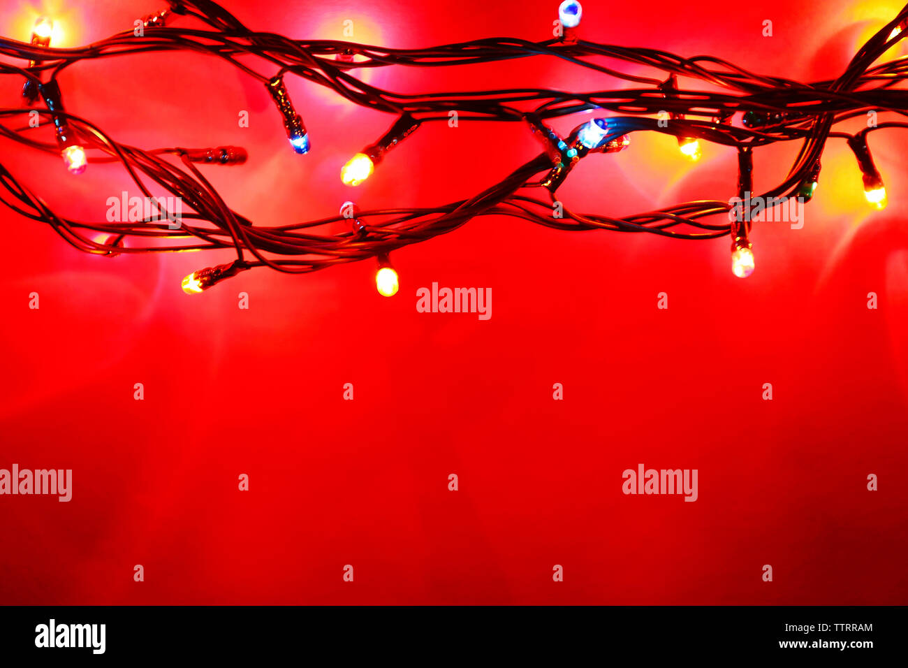 Christmas lights on color background Stock Photo - Alamy