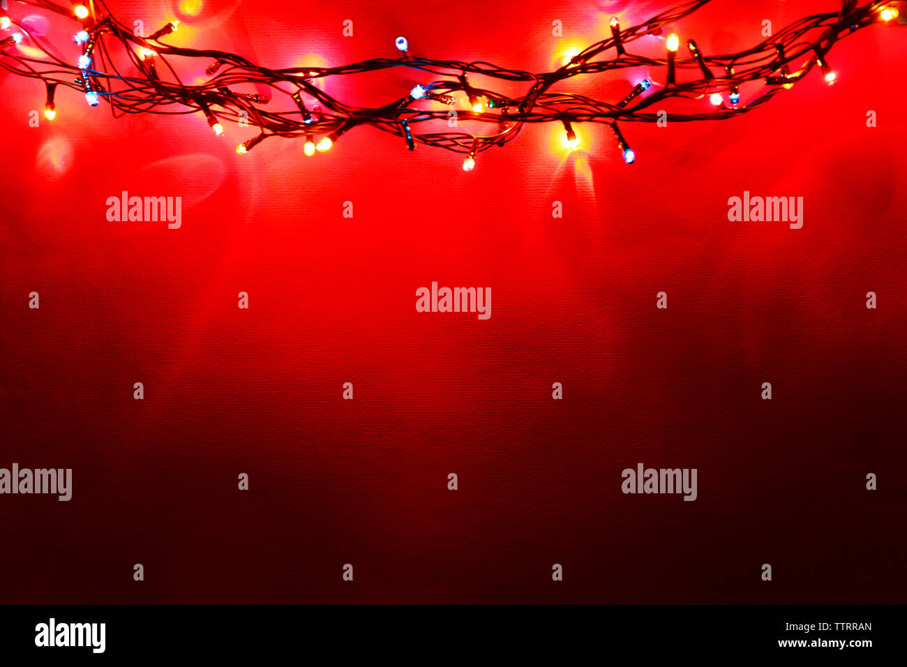 Christmas lights on color background Stock Photo - Alamy