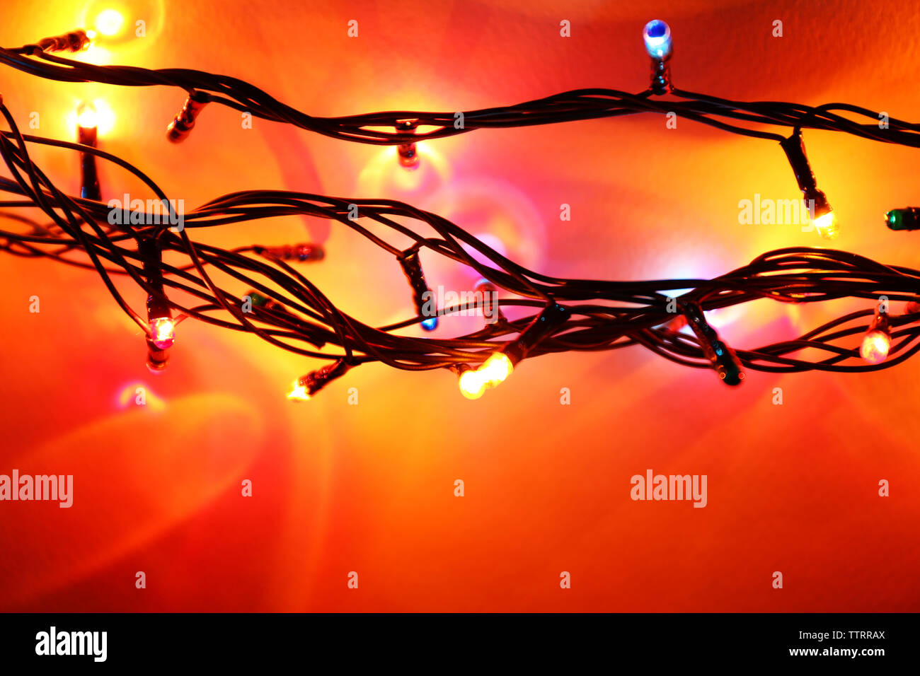 Christmas lights on color background Stock Photo - Alamy