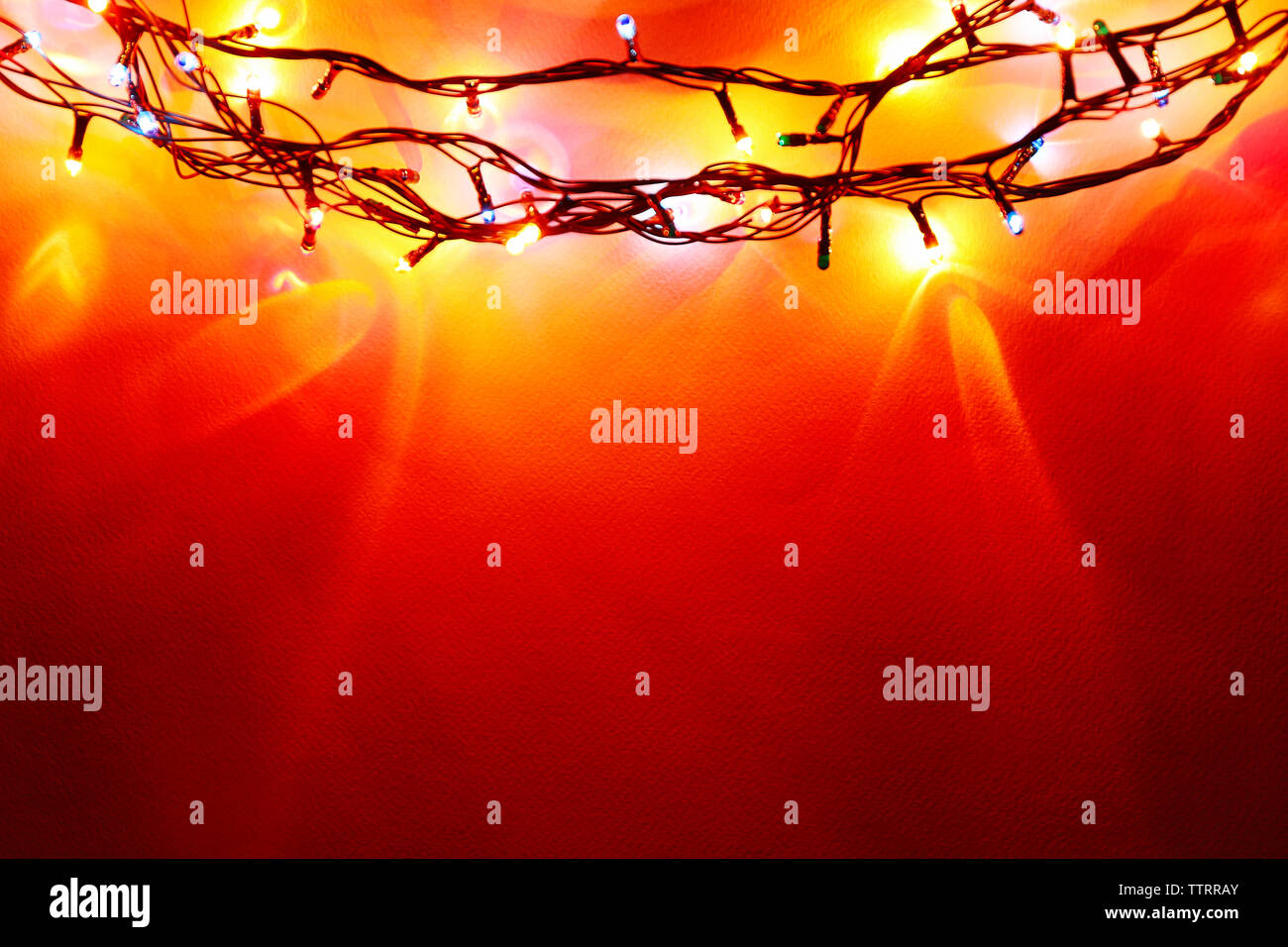 Christmas lights on color background Stock Photo - Alamy