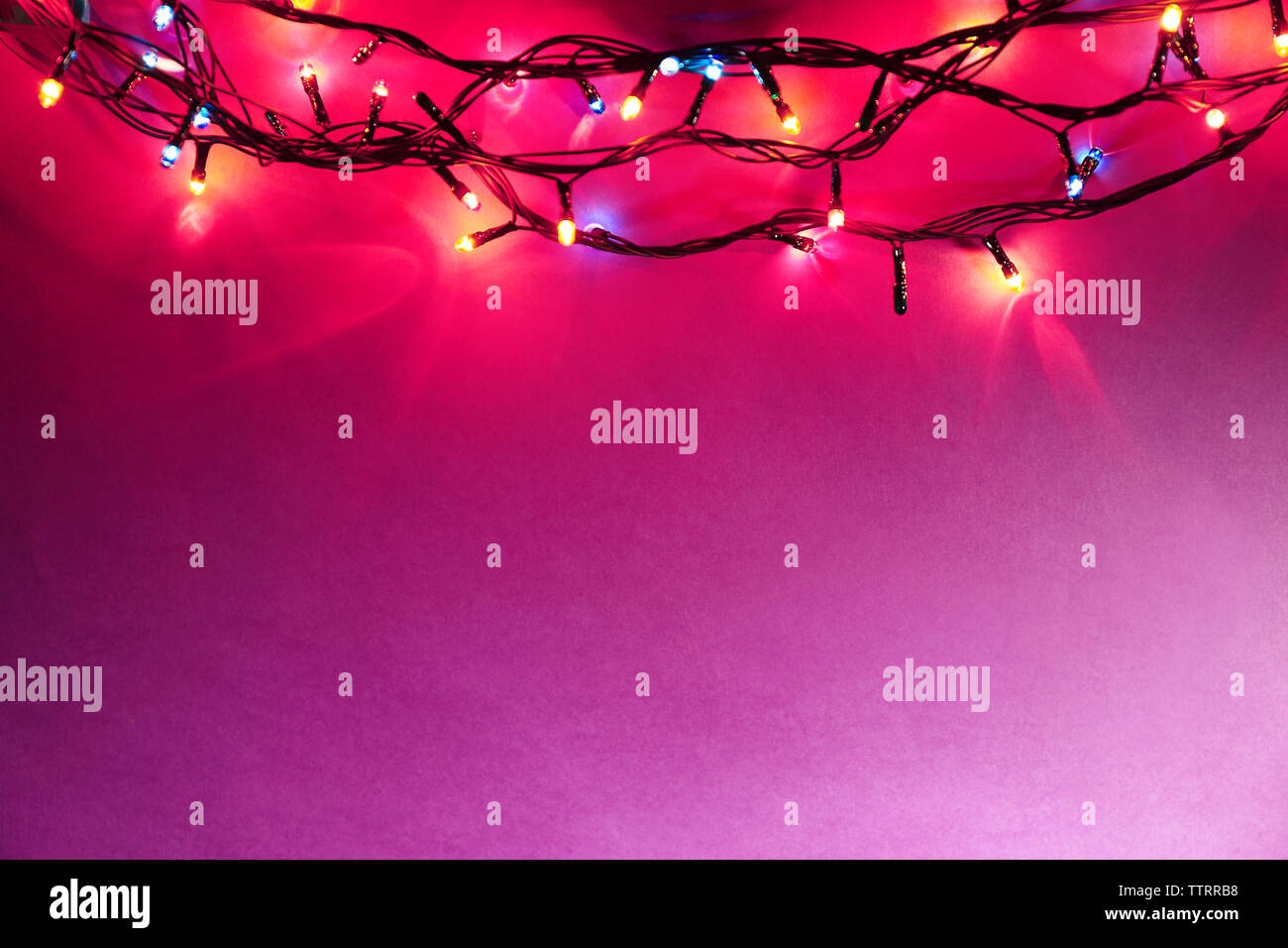 Christmas lights on color background Stock Photo - Alamy