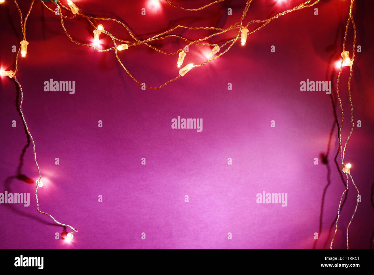 Christmas lights on color background Stock Photo - Alamy