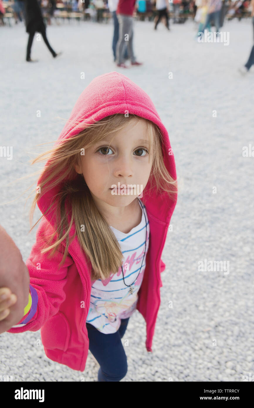 Portrait of cute girl walking at town square Stock Photo - Alamy