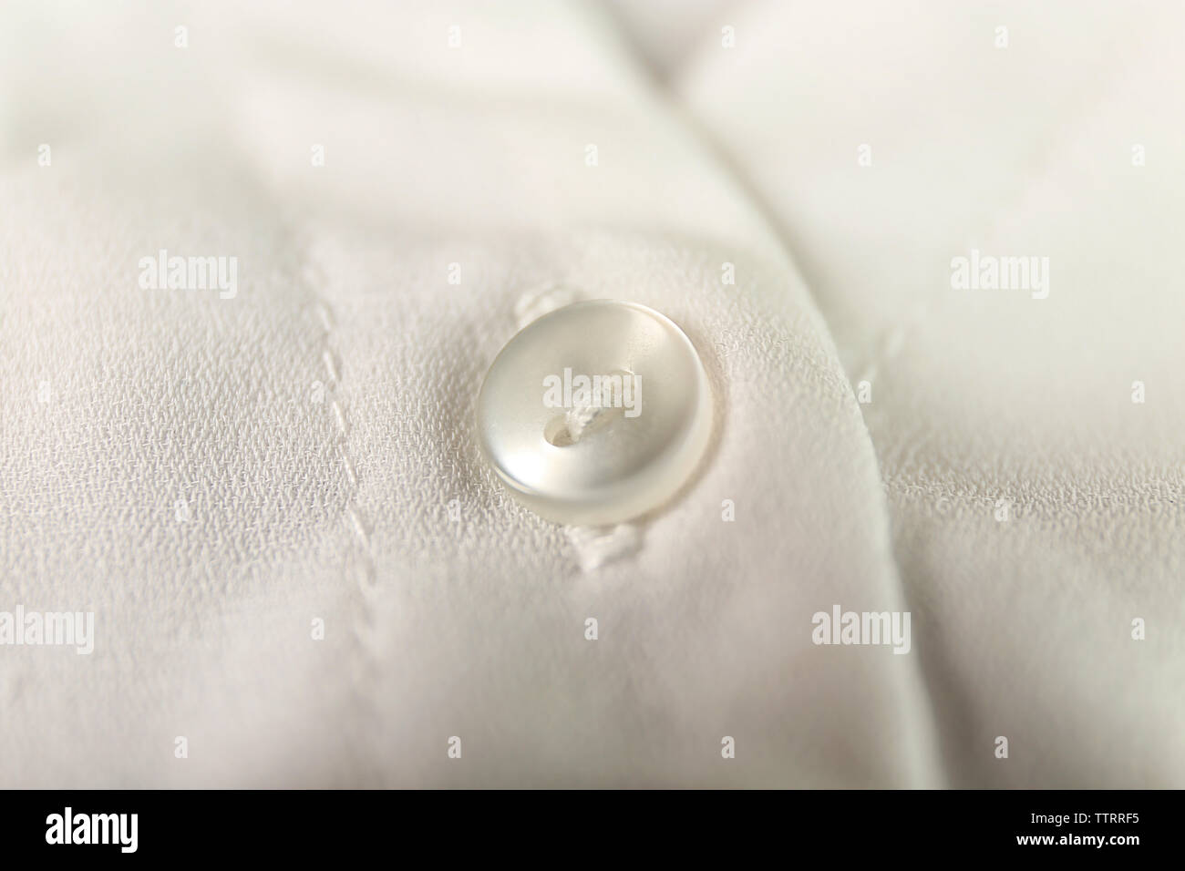Button on clothes, close up Stock Photo - Alamy