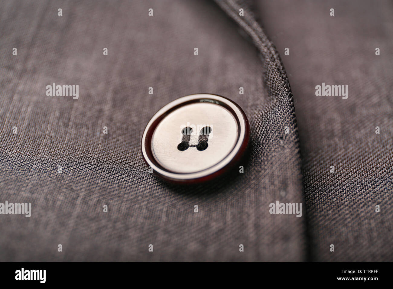 Button on clothes, close up Stock Photo - Alamy