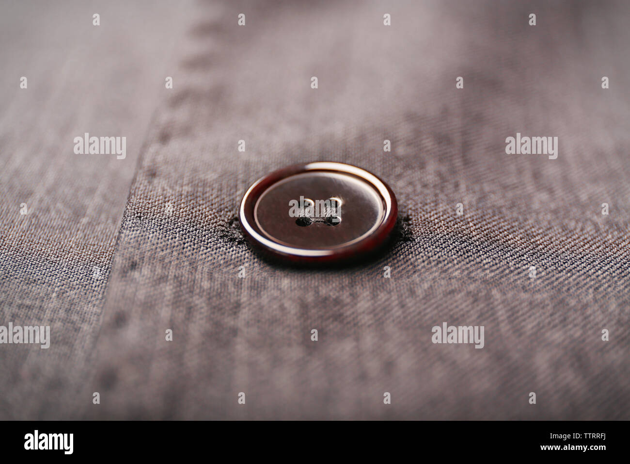 Button on clothes, close up Stock Photo - Alamy