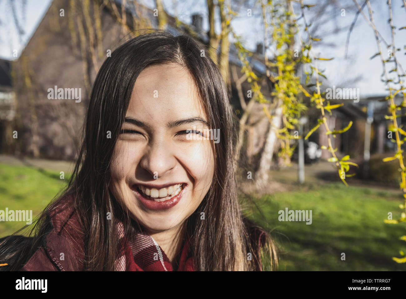 The portrait of smiling mixed race woman on country side in sunny day ...