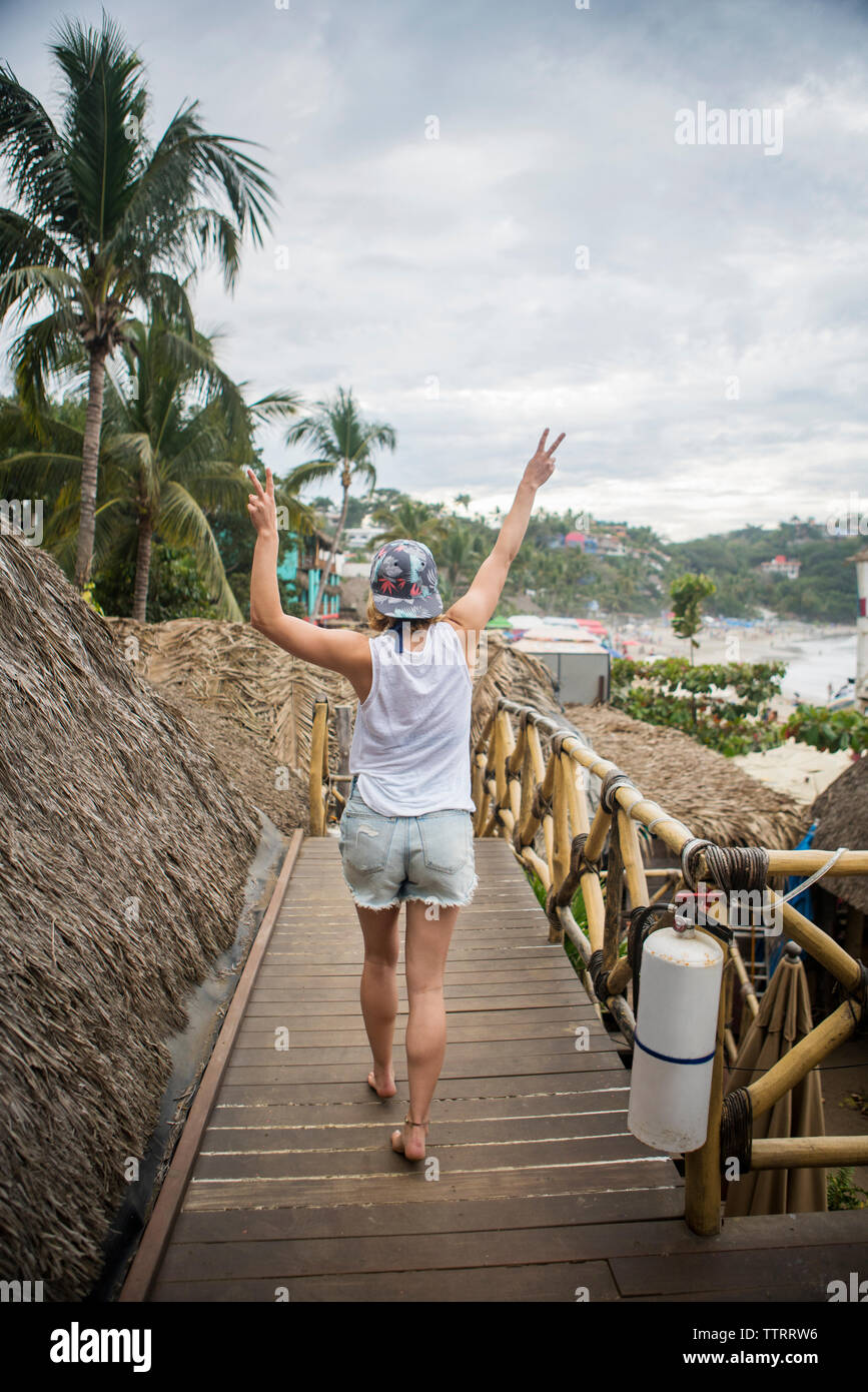 Woman arms raised rear view sky hi-res stock photography and images - Alamy
