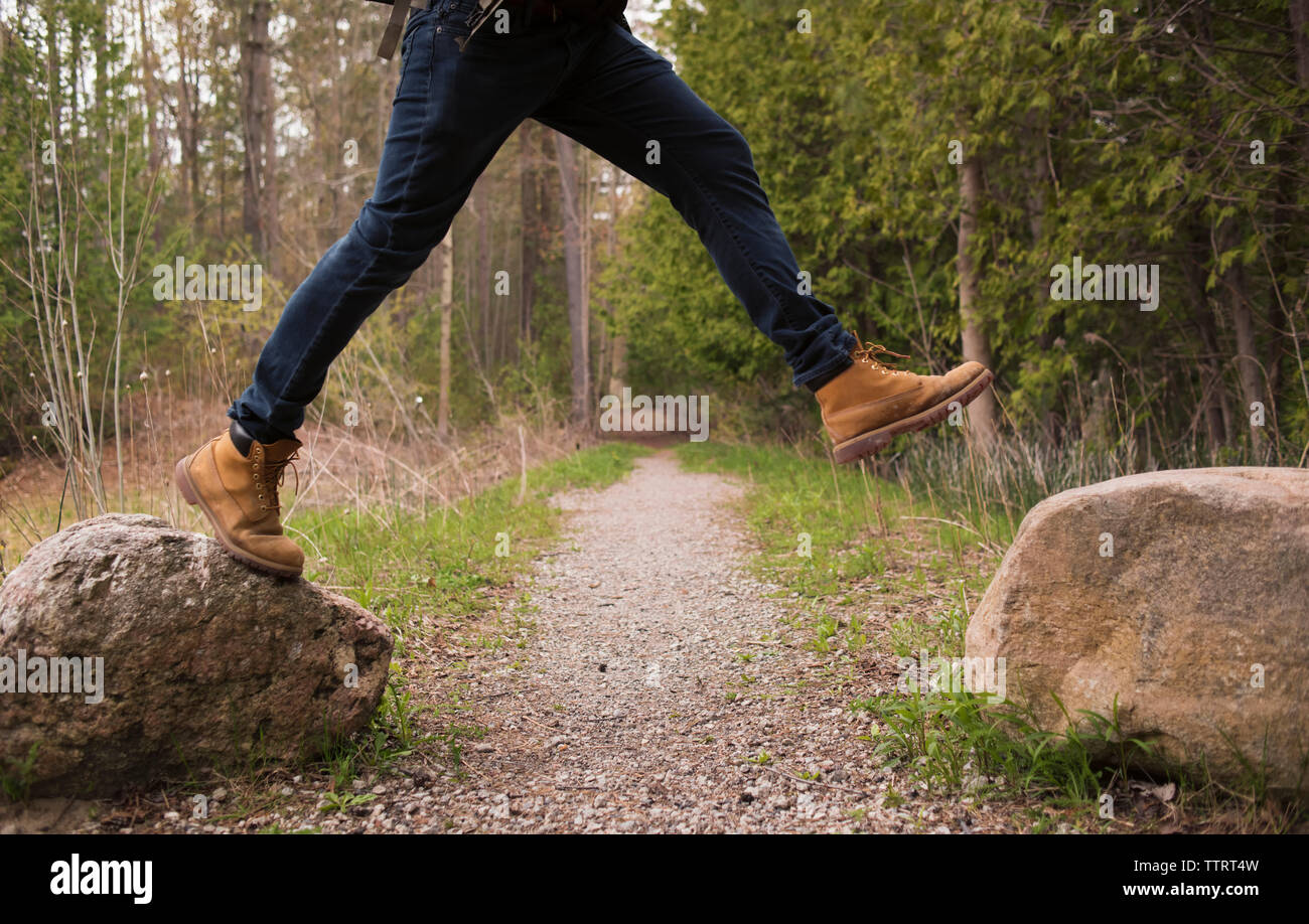 Man jumping over rocks hi-res stock photography and images - Alamy