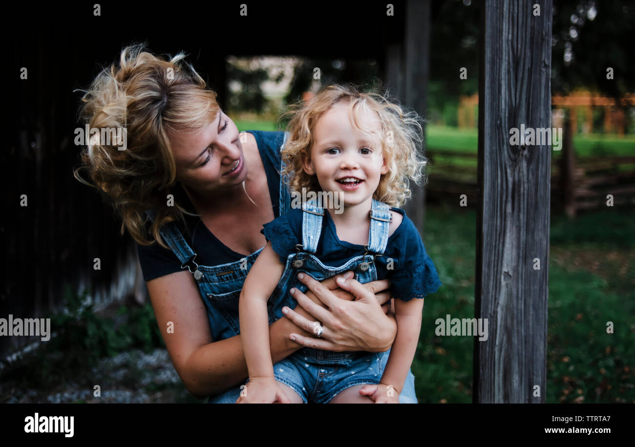 Portrait of cute daughter with mother at farm Stock Photo - Alamy