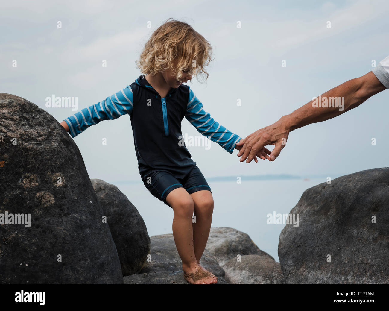 Father standing on rocks hi-res stock photography and images - Alamy