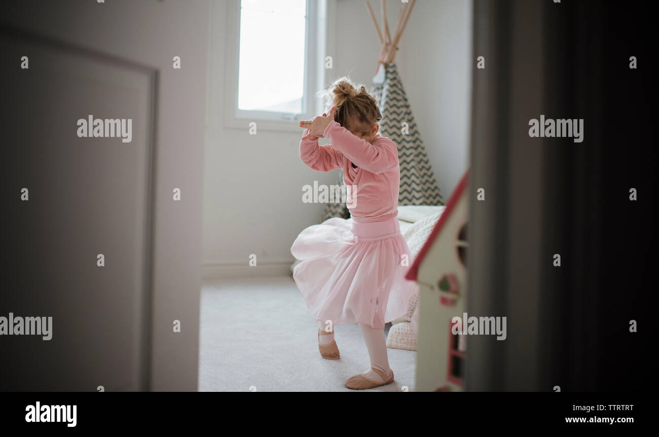 Girl in ballet costume dancing at home seen through doorway Stock Photo ...