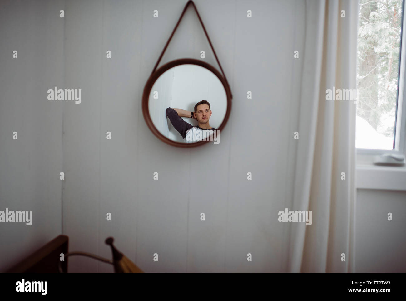 Thoughtful man reflecting on mirror at home Stock Photo - Alamy