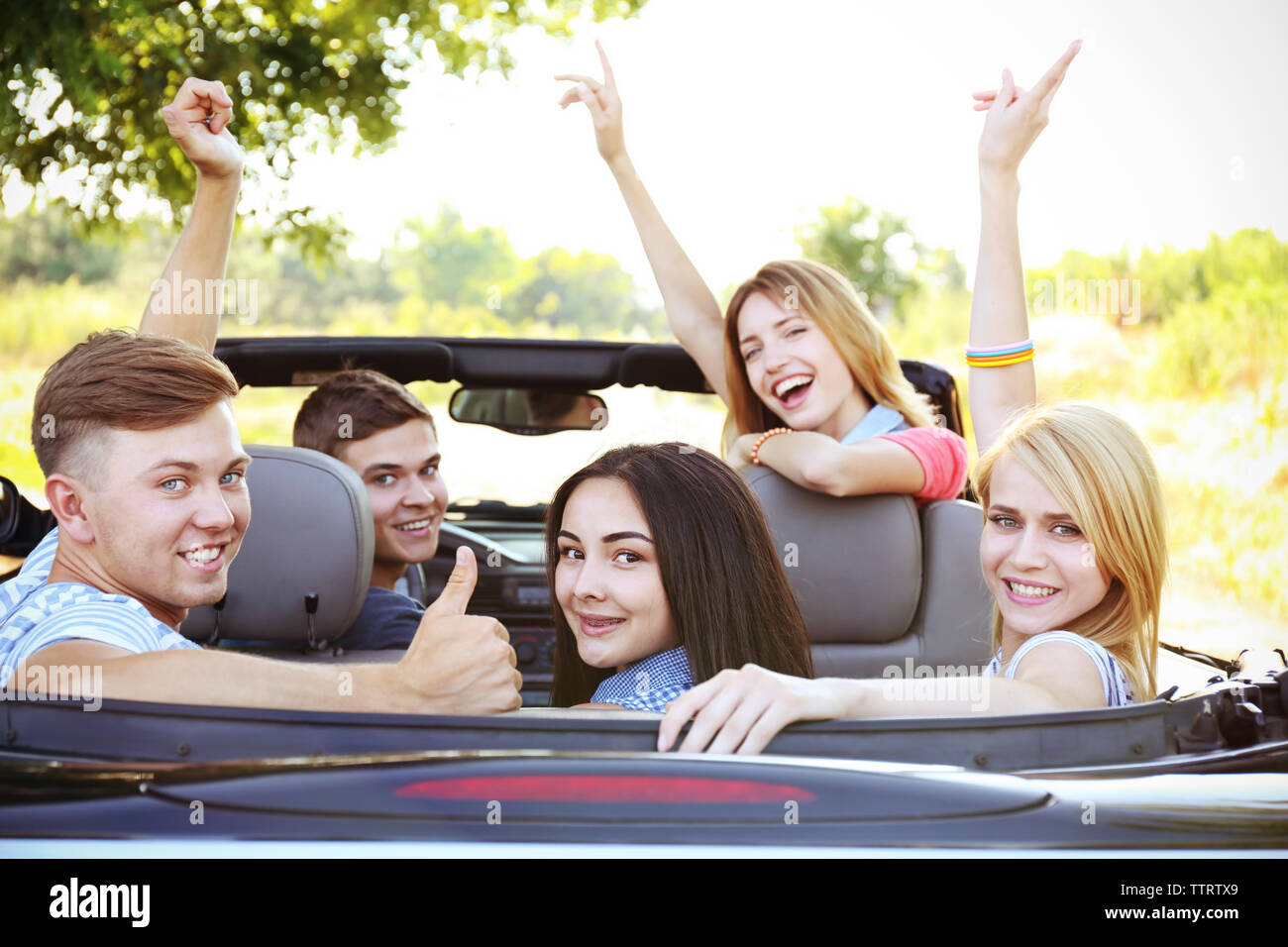 Happy friends in car Stock Photo - Alamy