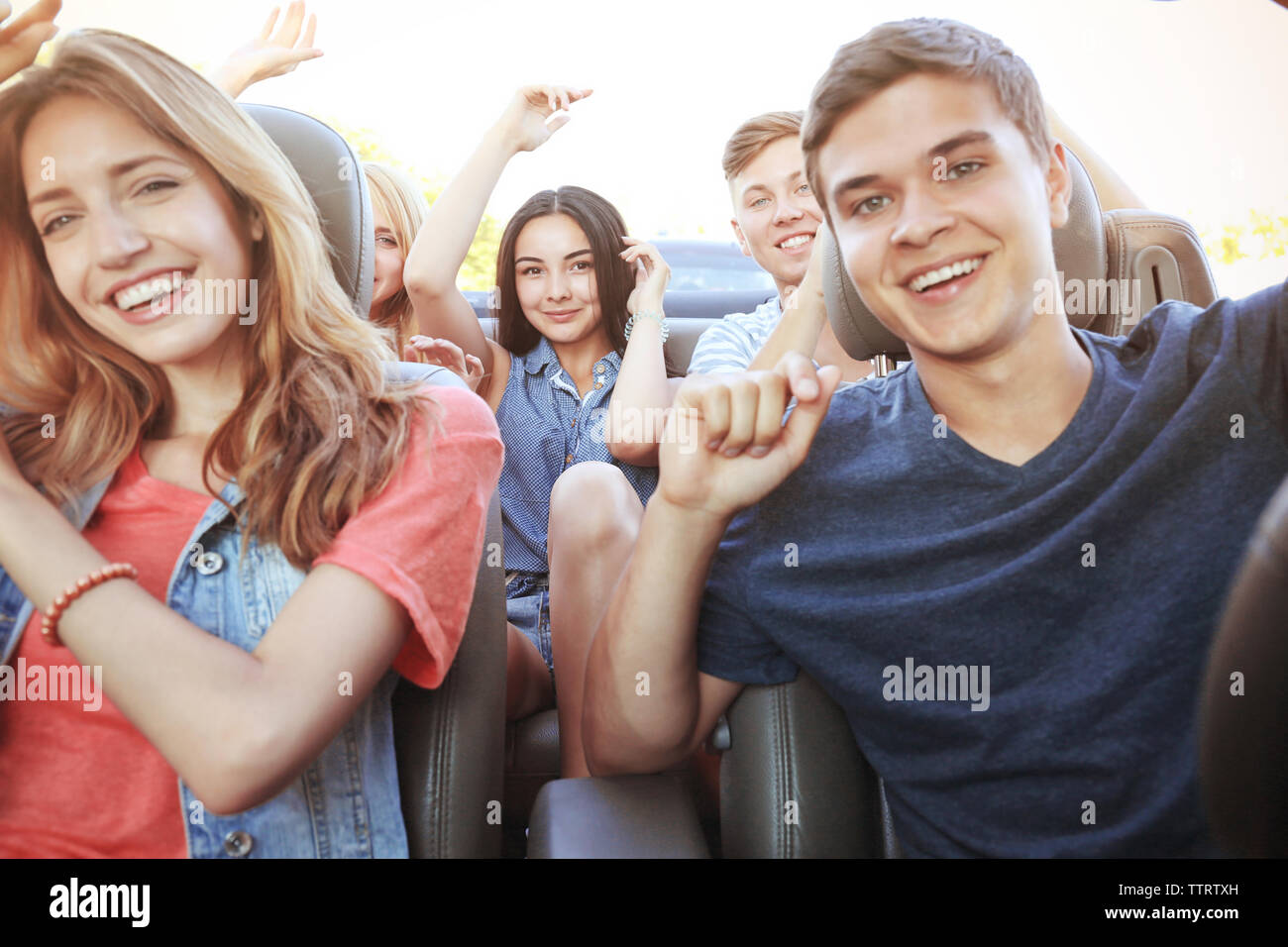 Happy friends in car Stock Photo - Alamy