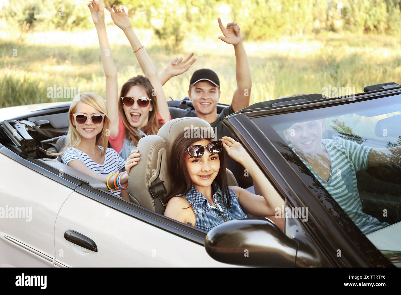 Happy friends in car Stock Photo - Alamy