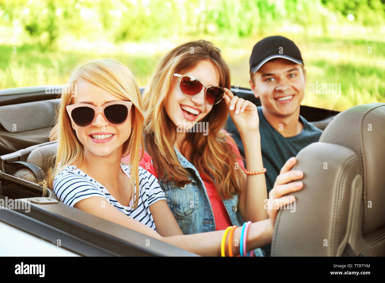 Happy friends in car Stock Photo - Alamy