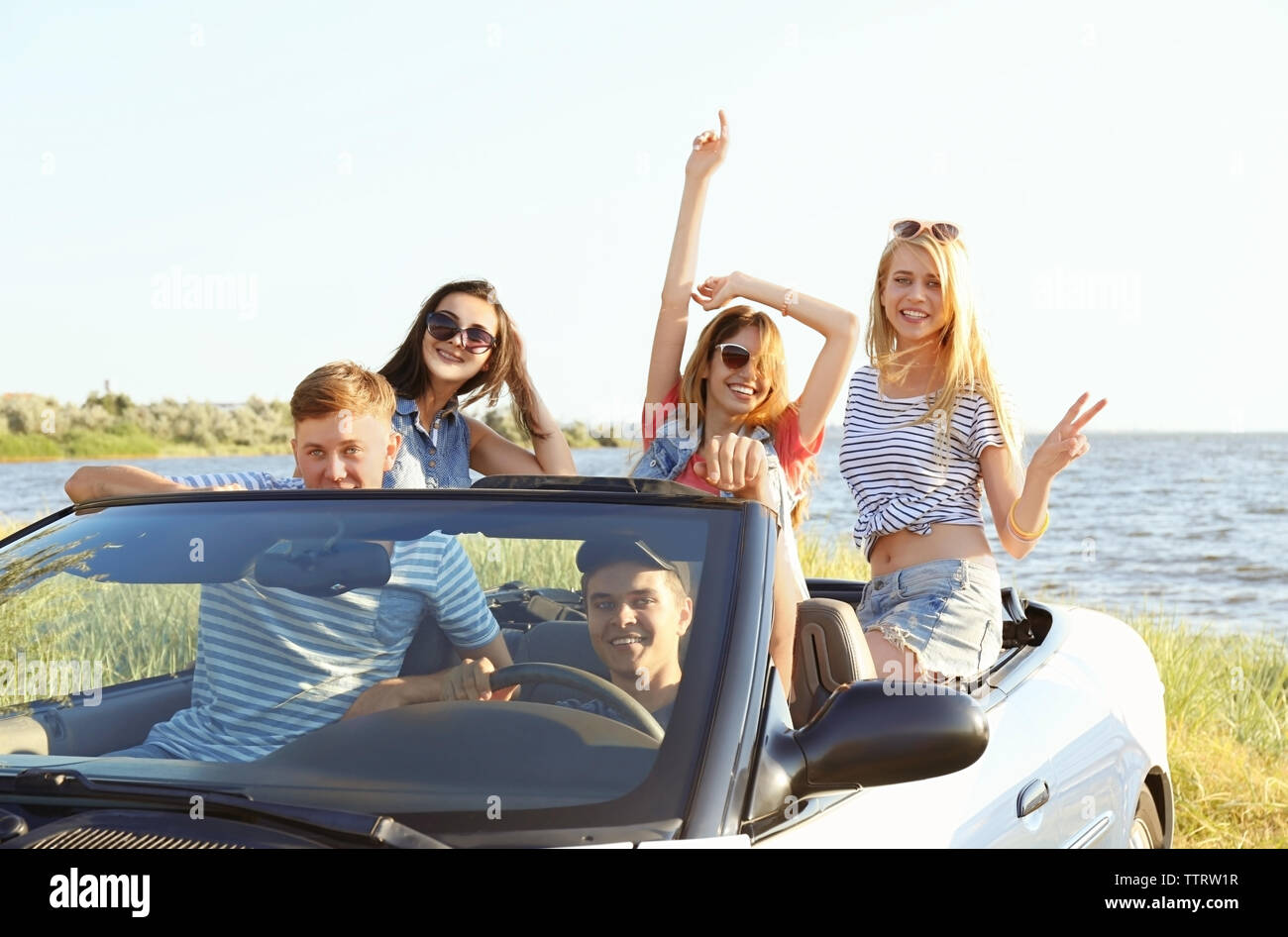 Happy friends in car Stock Photo - Alamy