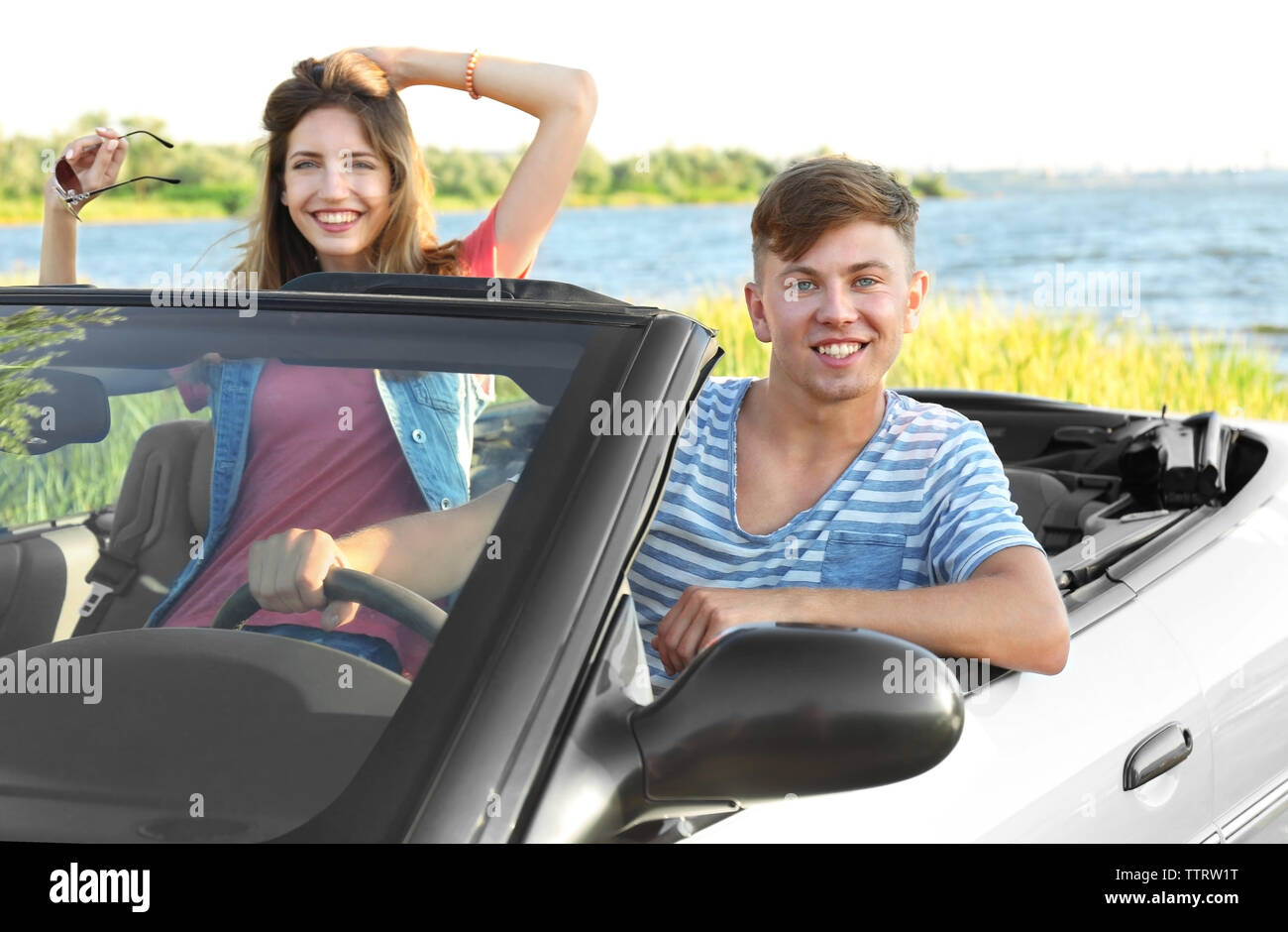 Happy friends in car Stock Photo - Alamy