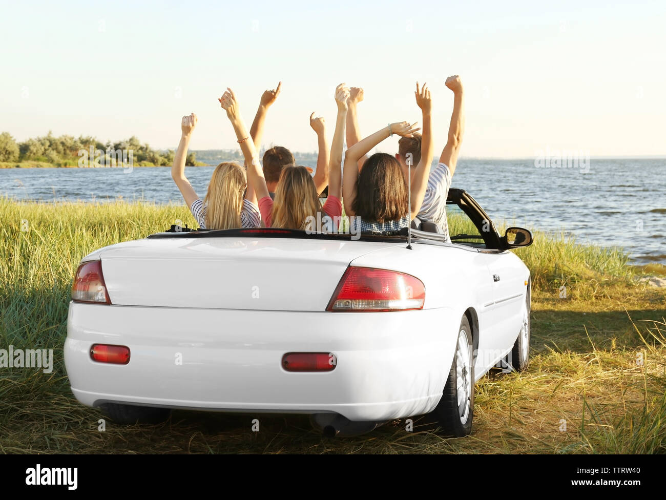 Happy friends in car Stock Photo - Alamy