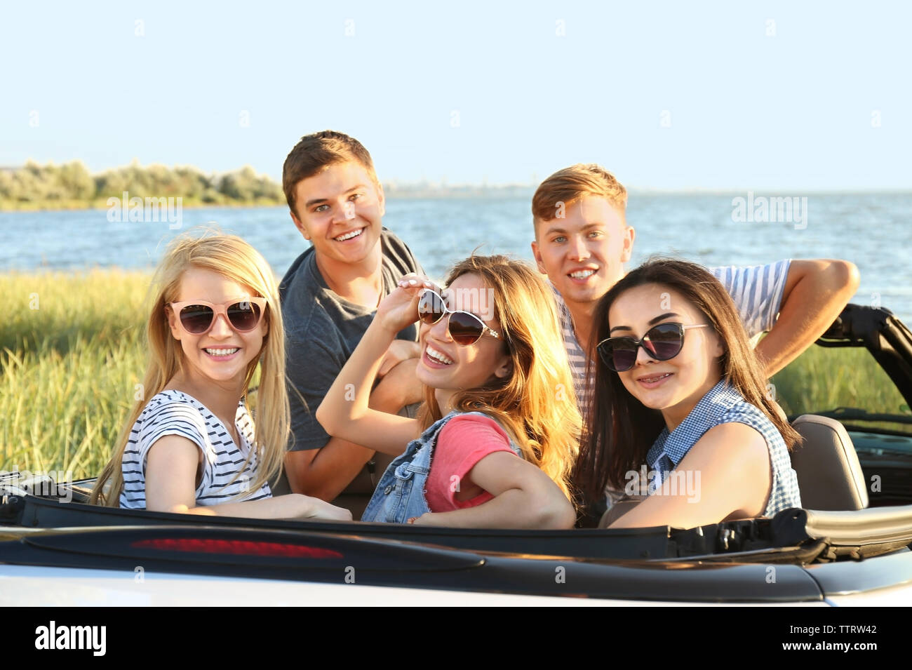 Happy friends in car Stock Photo - Alamy