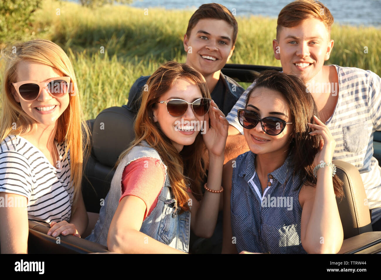 Happy friends in car Stock Photo - Alamy