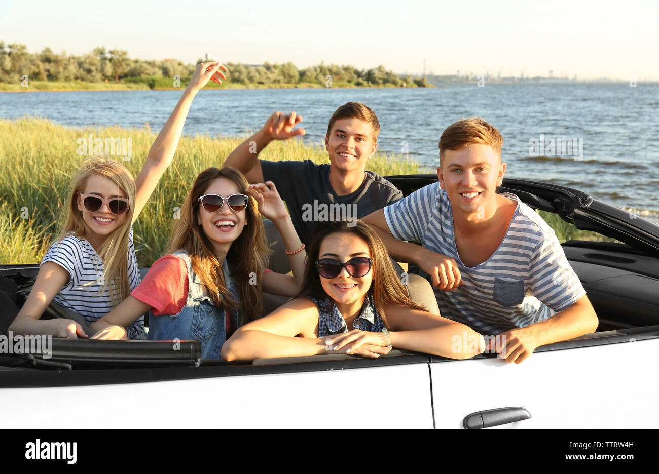 Happy friends in car Stock Photo - Alamy