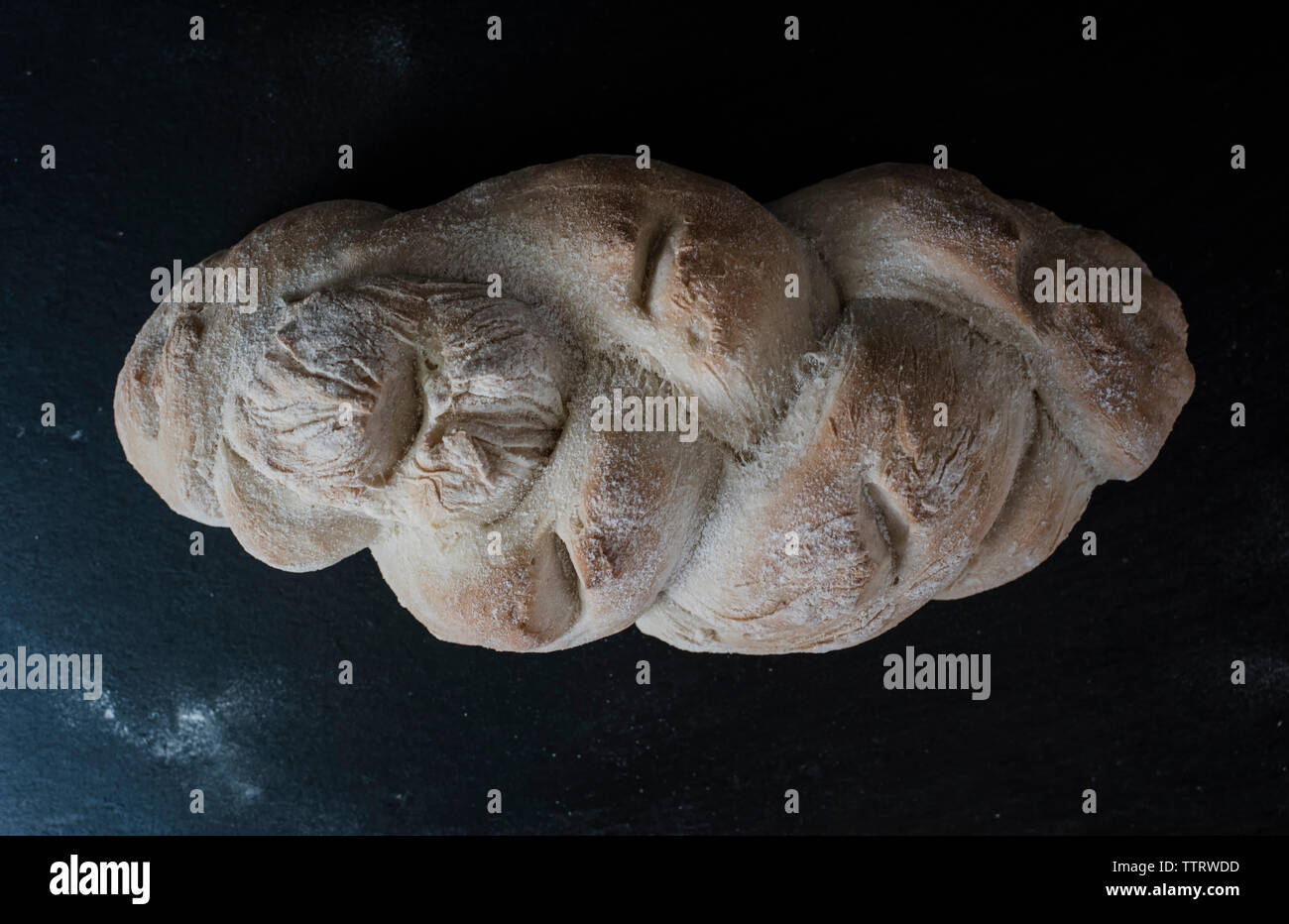 Overhead view of baked braided bread on slate at home Stock Photo - Alamy