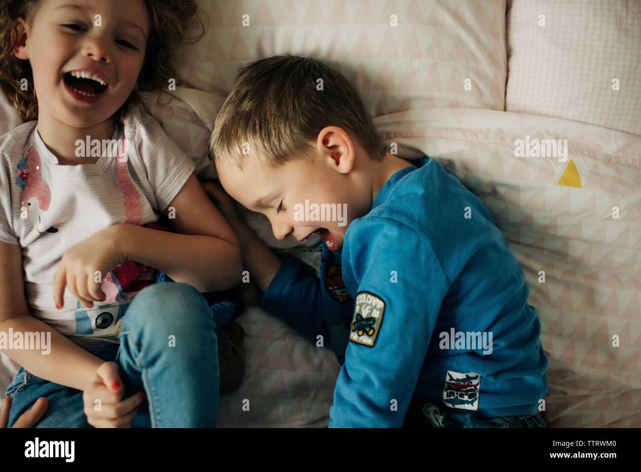 brother and sister having fun laughing in bedroom. siblings Stock Photo ...