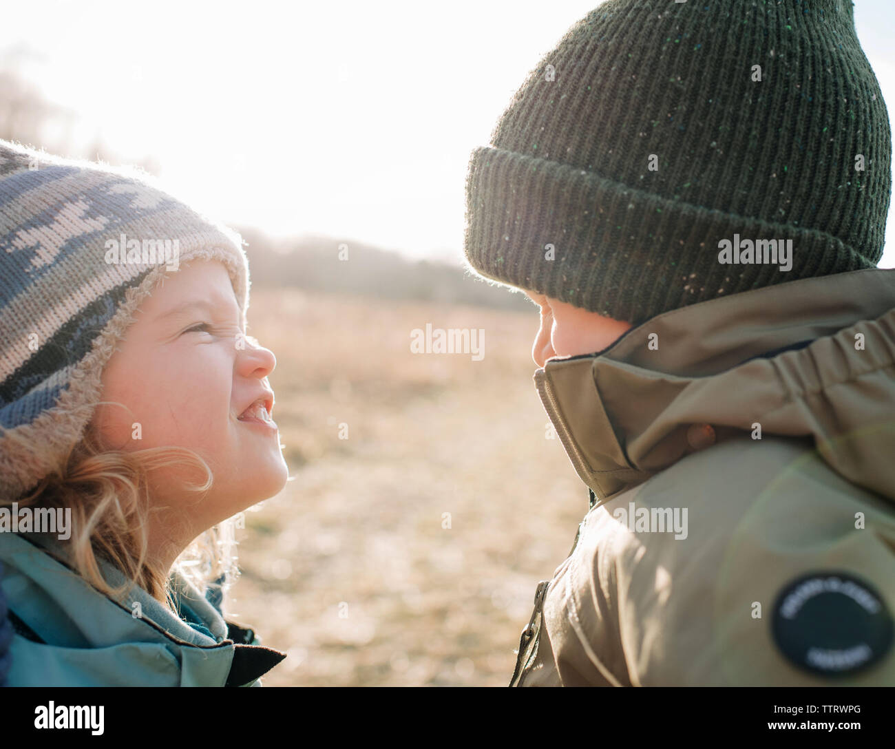 boy and girl making silly faces at each other playing outside Stock ...